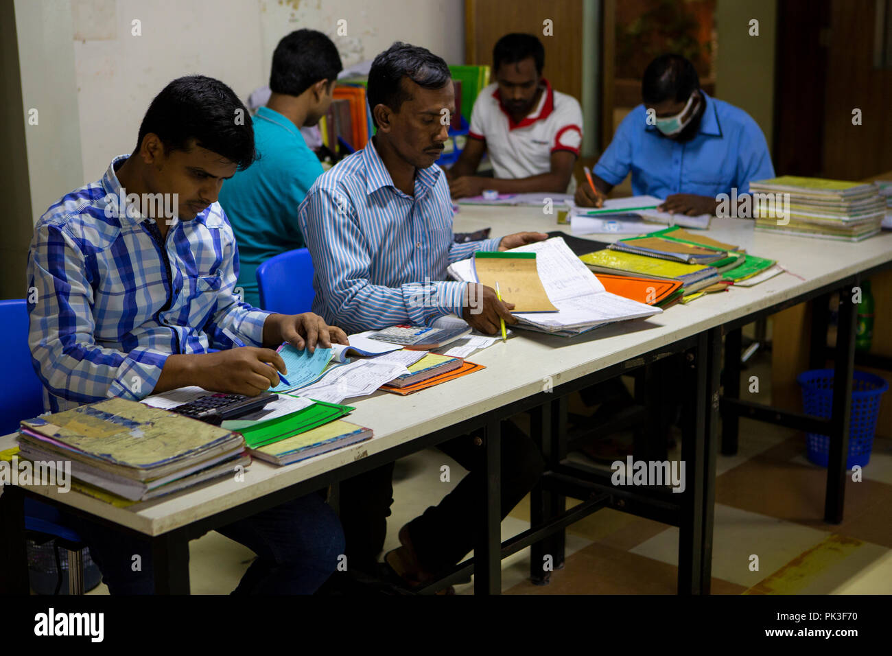 Stock check, accounting and processing orders inside a garment factory ...
