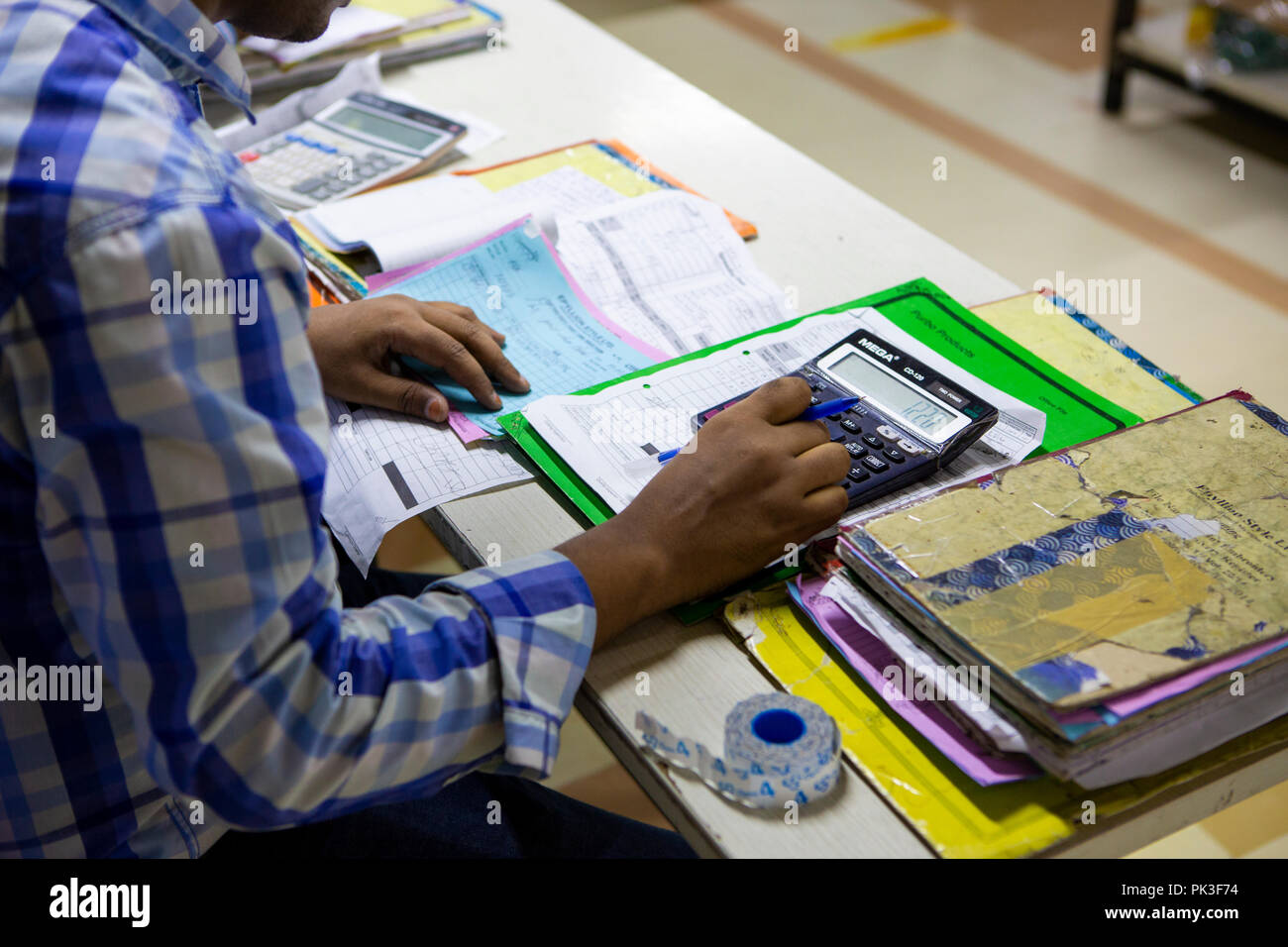 Stock check, accounting and processing orders inside a garment factory ...
