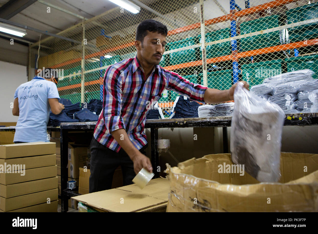 Clothes being boxed up ready for collection from a garment factory in ...