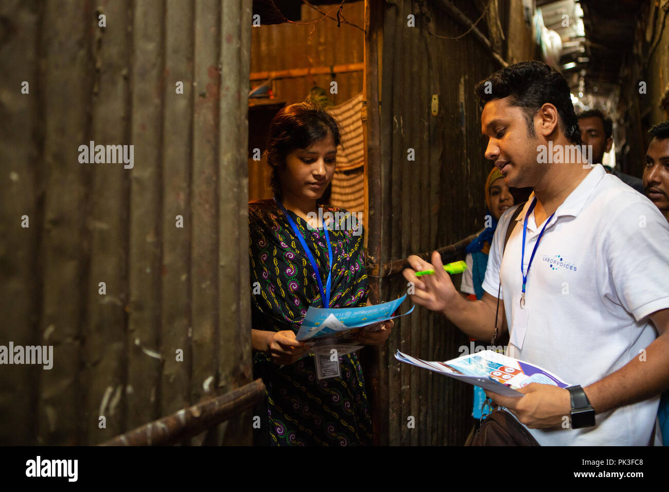 A garment worker using a mobile phone to share feedback on the working ...