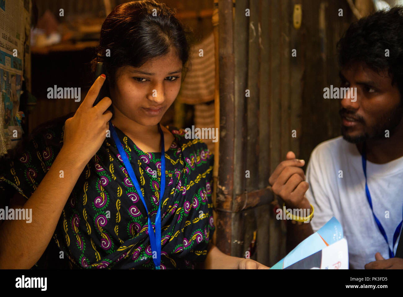 A garment worker using a mobile phone to share feedback on the working ...