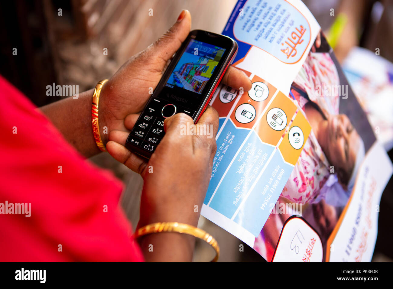 A garment worker using a mobile phone to share feedback on the working ...
