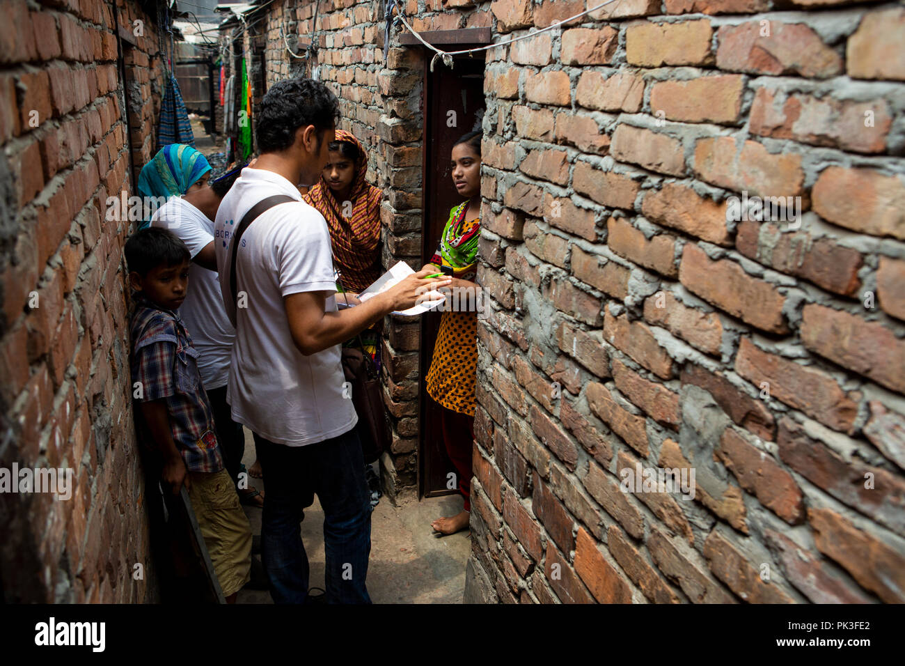 Community field staff out talking to garment workers in the slums where ...
