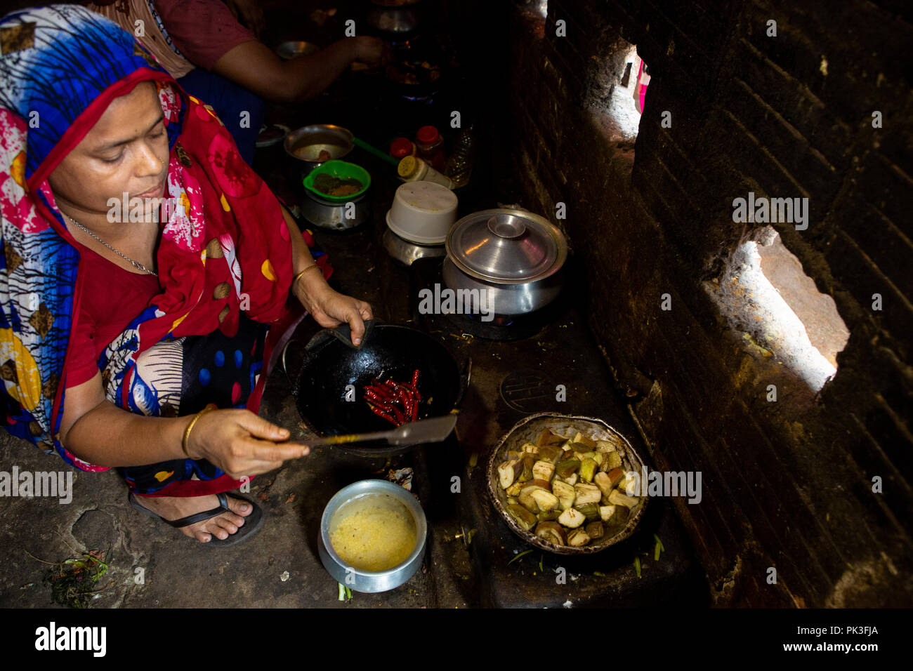 Curry being cooked in a communal kitchen where lots of garment workers ...