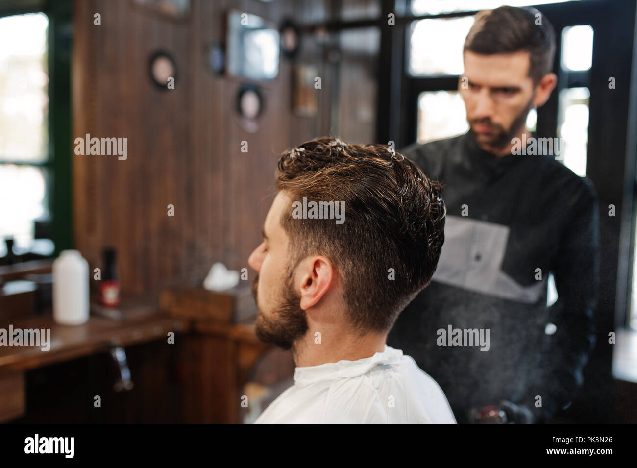Handsome bearded man at the barbershop, barber at work Stock Photo - Alamy