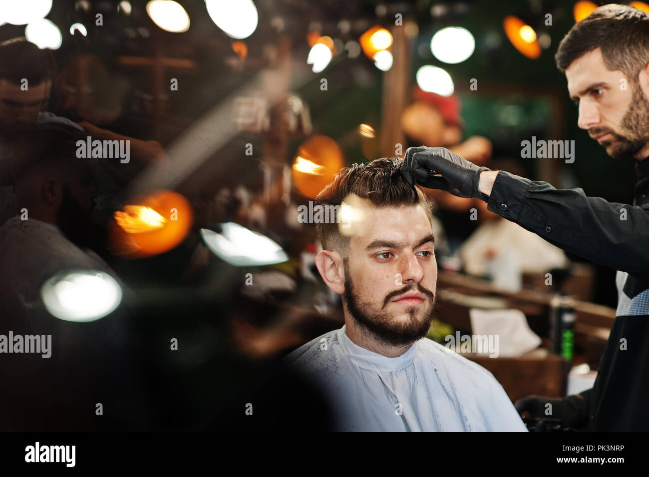 Handsome bearded man at the barbershop, barber at work Stock Photo - Alamy