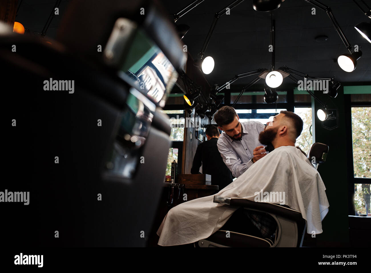 Handsome bearded man at the barbershop, barber at work Stock Photo - Alamy