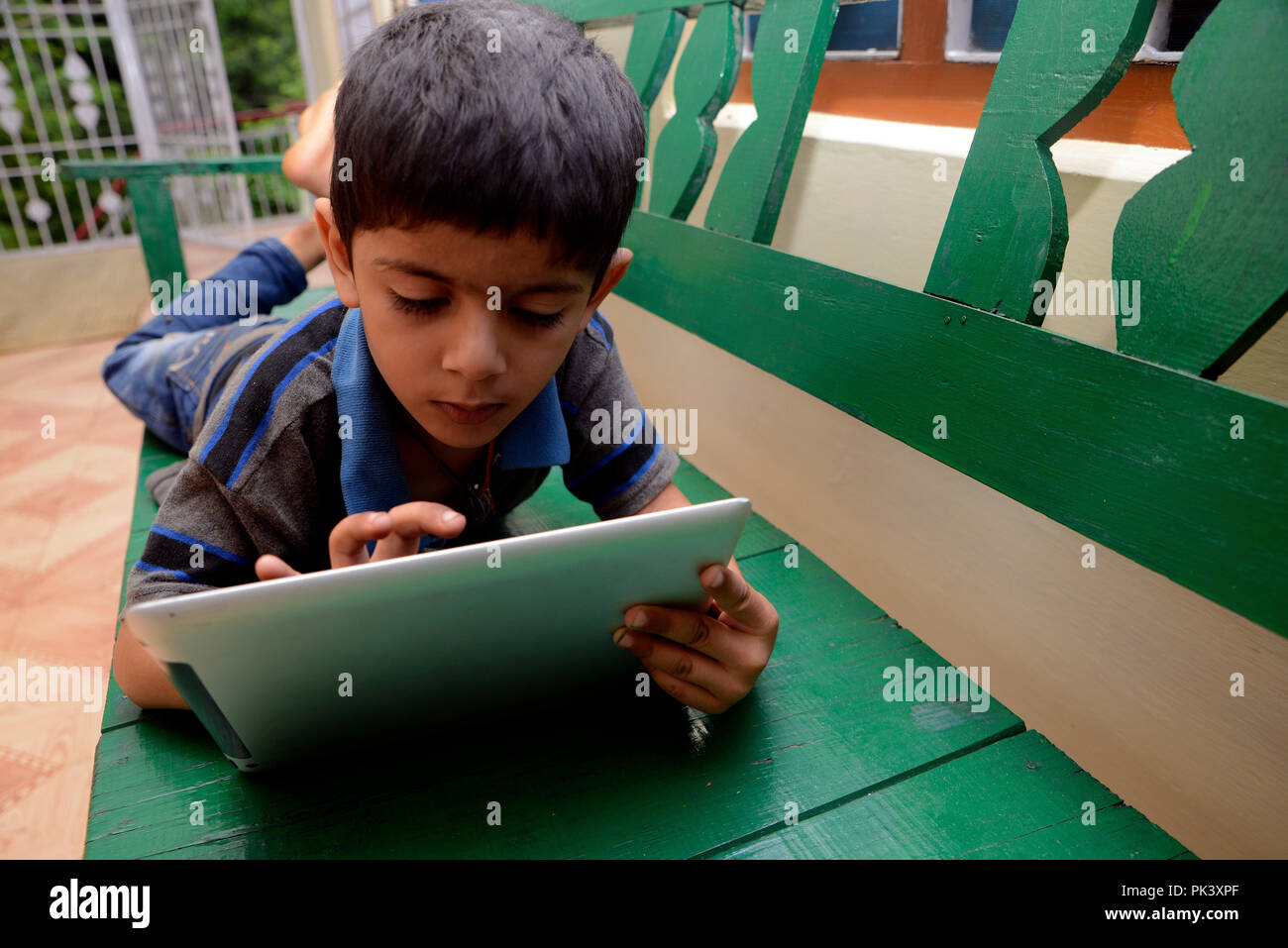 Little boy playing with digital tablet Stock Photo - Alamy