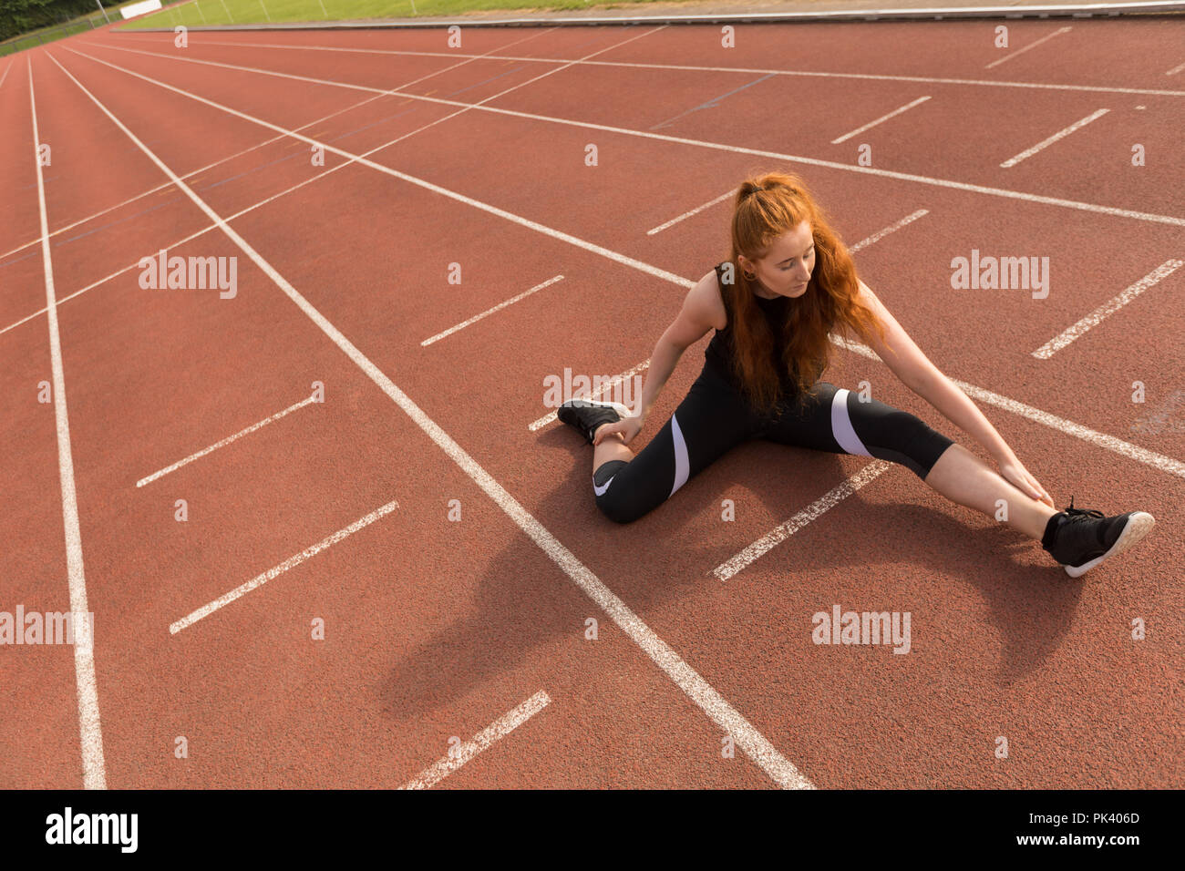 Female athletic exercising on running track Stock Photo - Alamy