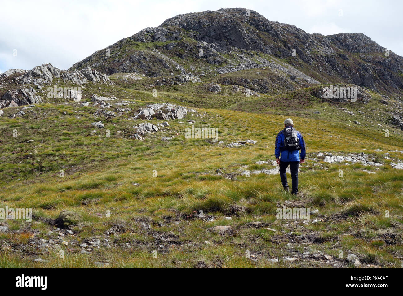 Man Walking on Bealach na Cruaiche towards the Scottish Mountain ...
