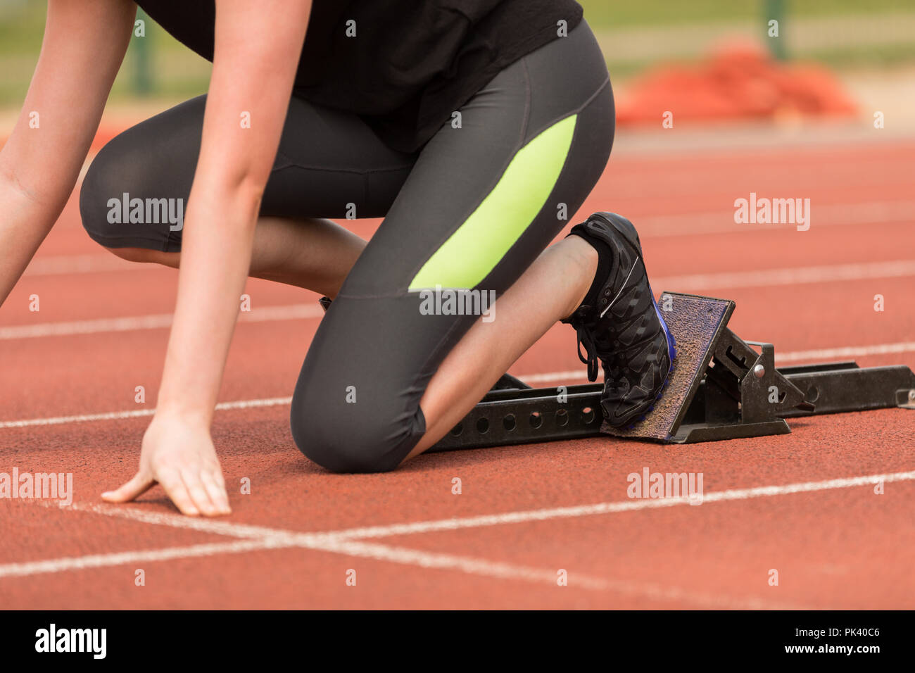 Female athlete ready to run on running track Stock Photo - Alamy