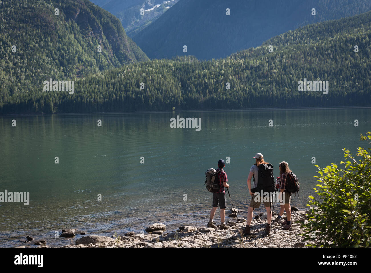 Hikers standing near riverside Stock Photo - Alamy