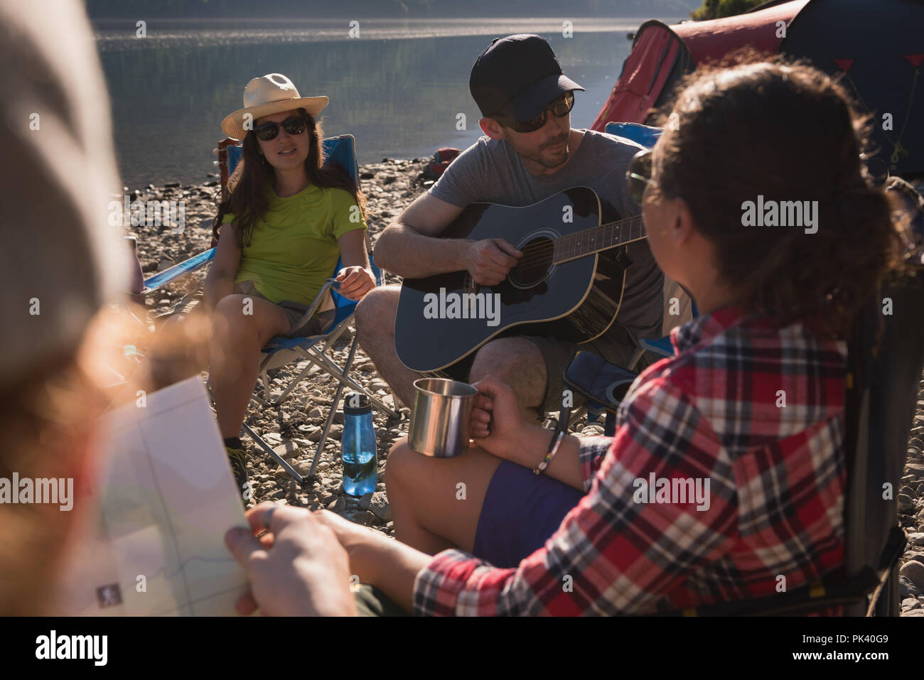 Group of friends camping near riverside Stock Photo - Alamy
