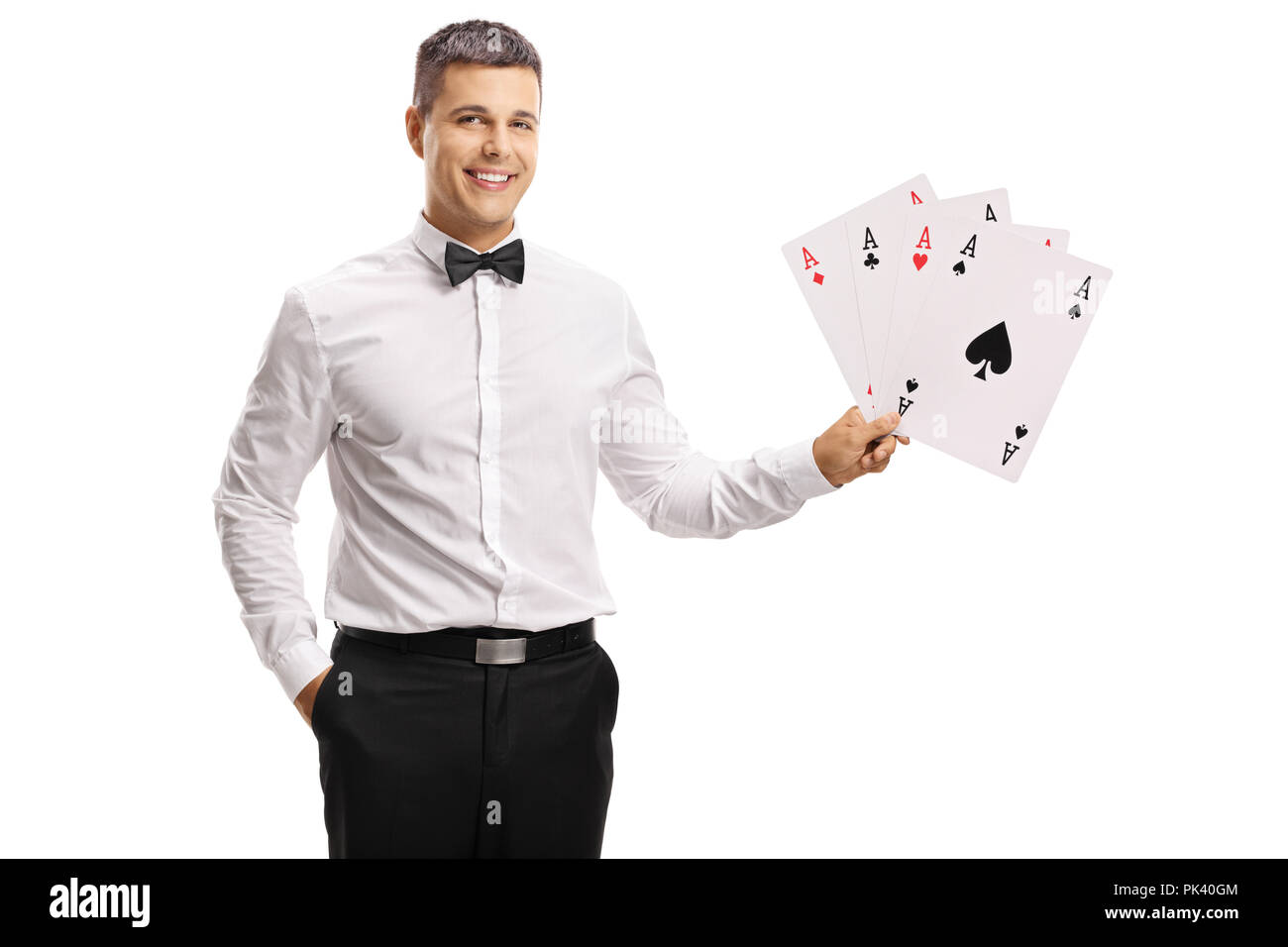 Handsome young man in a tux holding playing cards isolated on white ...