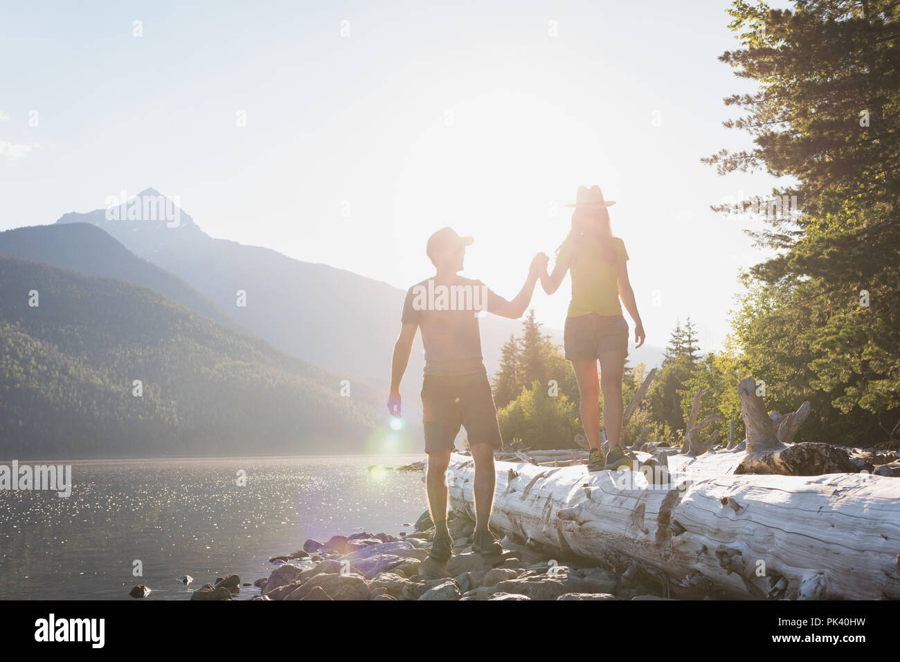 Couple holding hands near riverside Stock Photo - Alamy