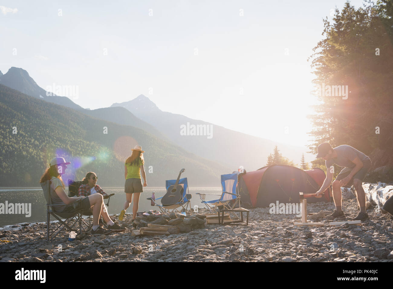 Group of friends camping near riverside Stock Photo - Alamy