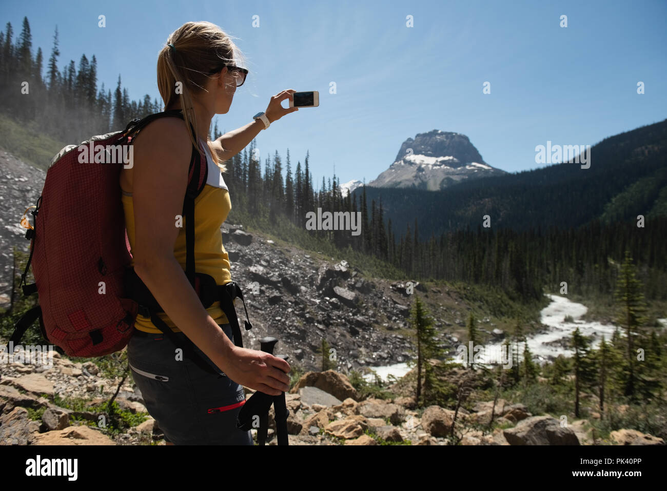 Female hiker taking selfie with mobile phone Stock Photo - Alamy