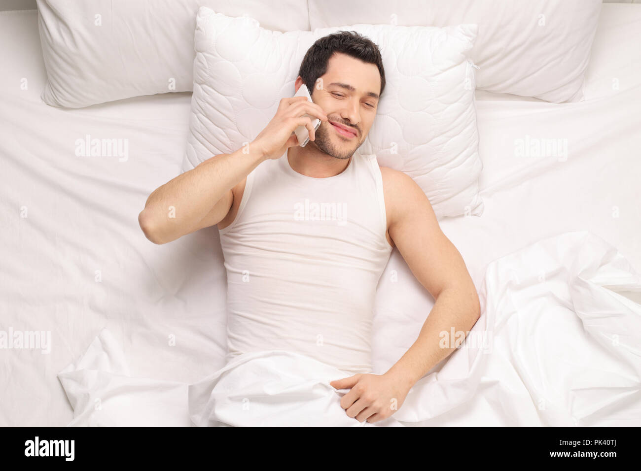 Handsome man lying on bed hi-res stock photography and images - Alamy