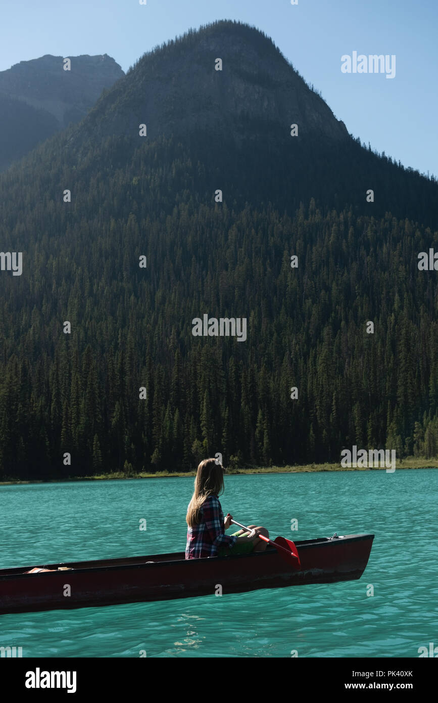 Woman rowing a boat on river Stock Photo - Alamy