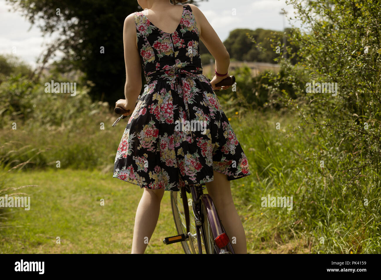 Woman riding bicycle hi-res stock photography and images - Alamy