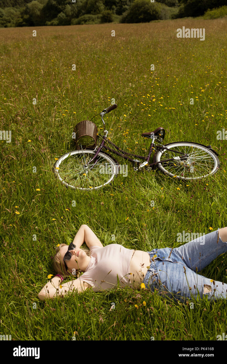 Woman relaxing in the field Stock Photo - Alamy