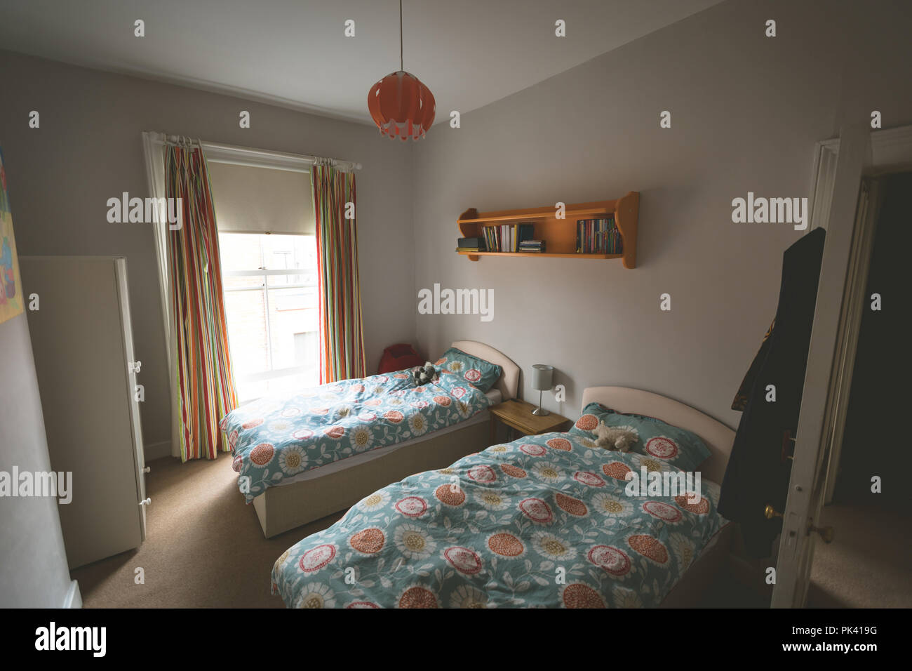 Bed in empty bedroom Stock Photo - Alamy