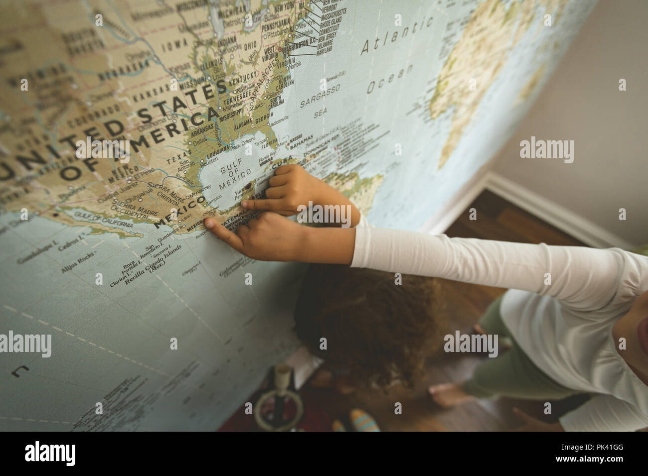 Siblings pointing towards map Stock Photo - Alamy