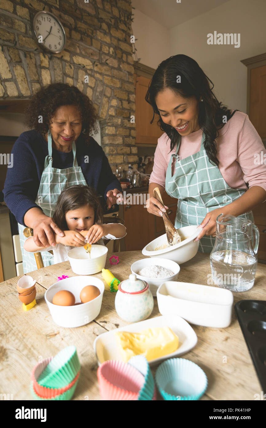 Family preparing breakfast on dining table Stock Photo - Alamy