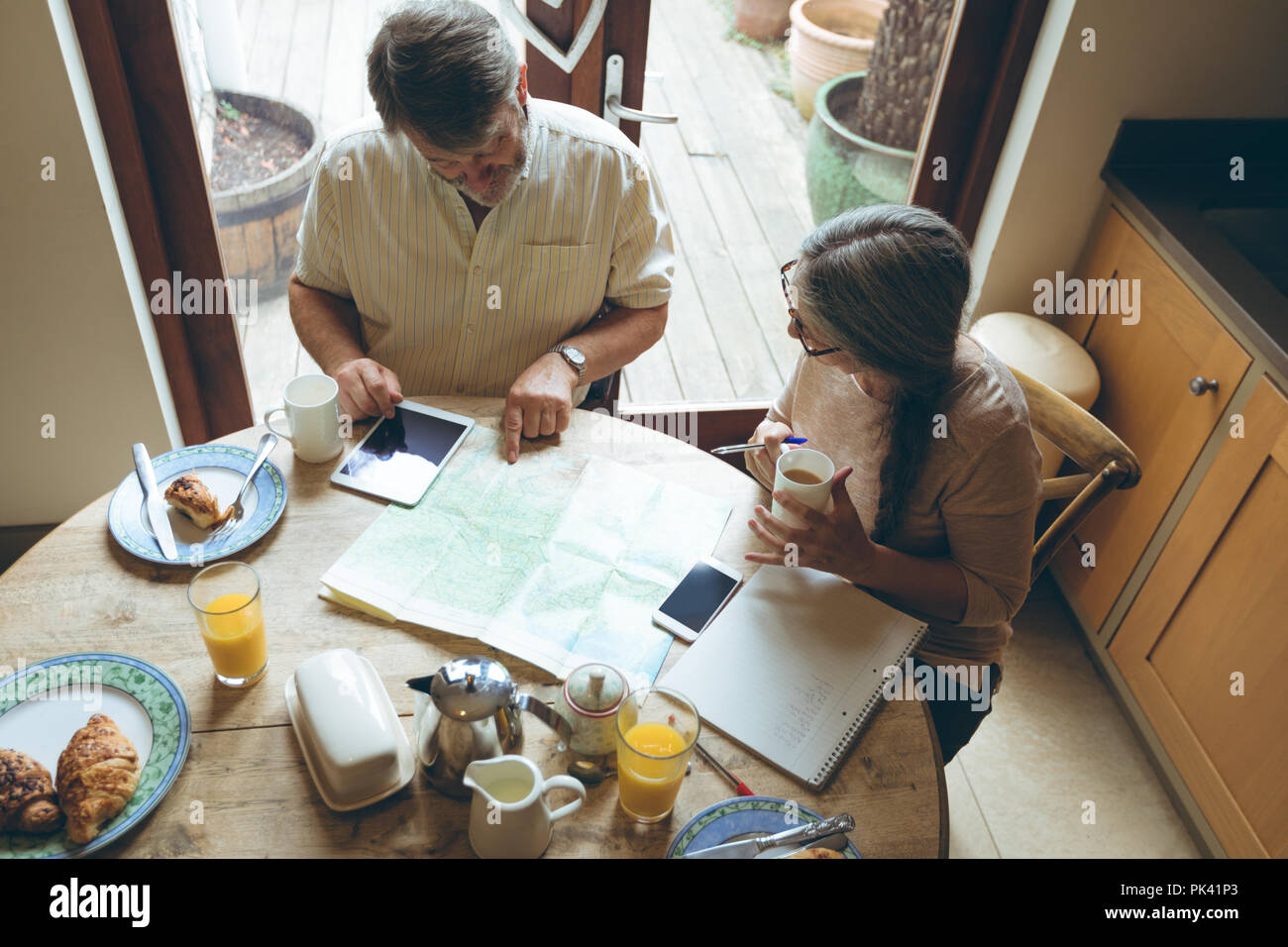 Senior couple discussing over a map Stock Photo - Alamy