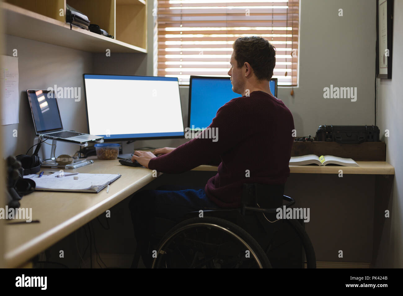Disabled man working on computer Stock Photo - Alamy