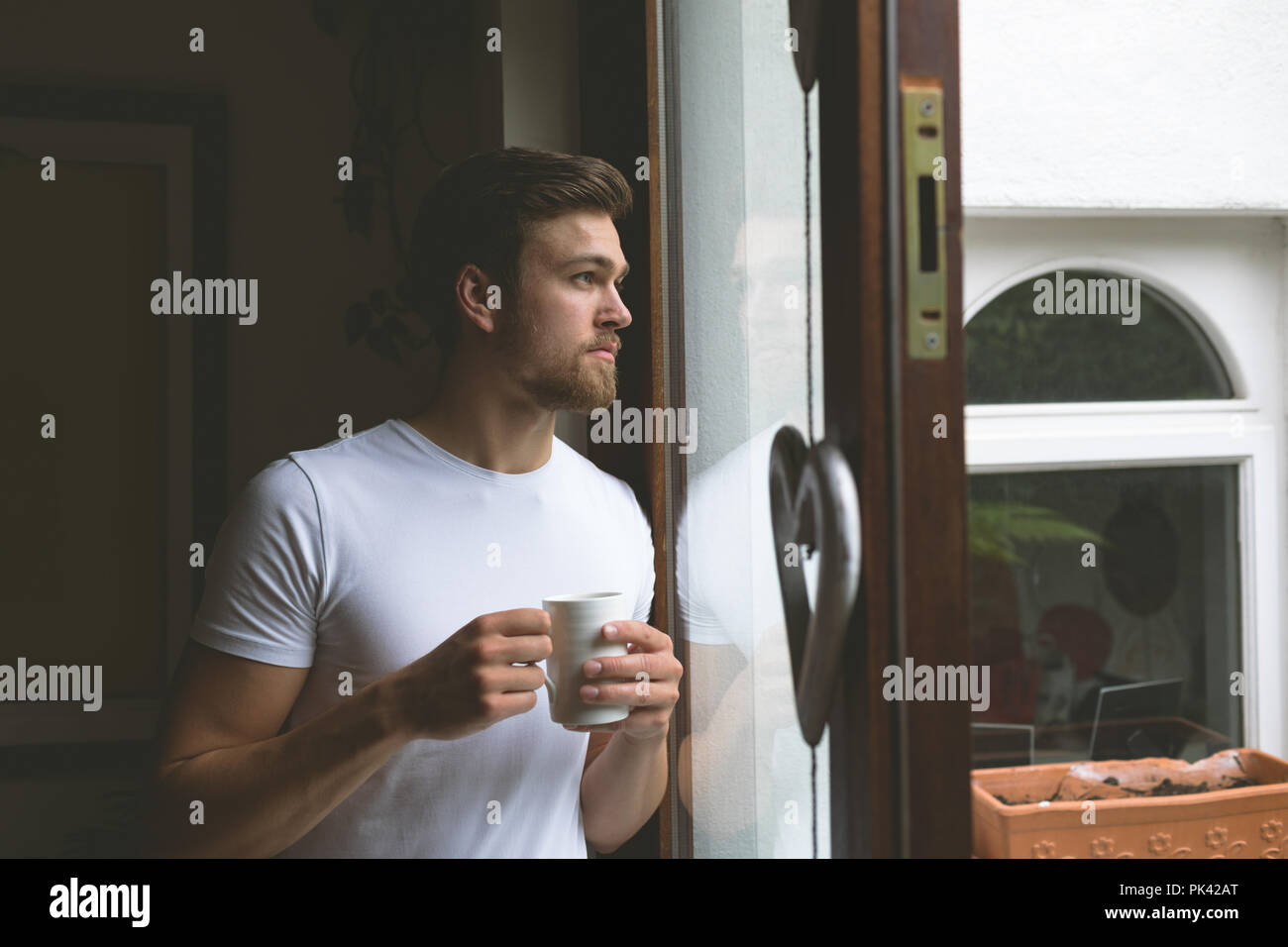 Young man having coffee home hi-res stock photography and images - Alamy