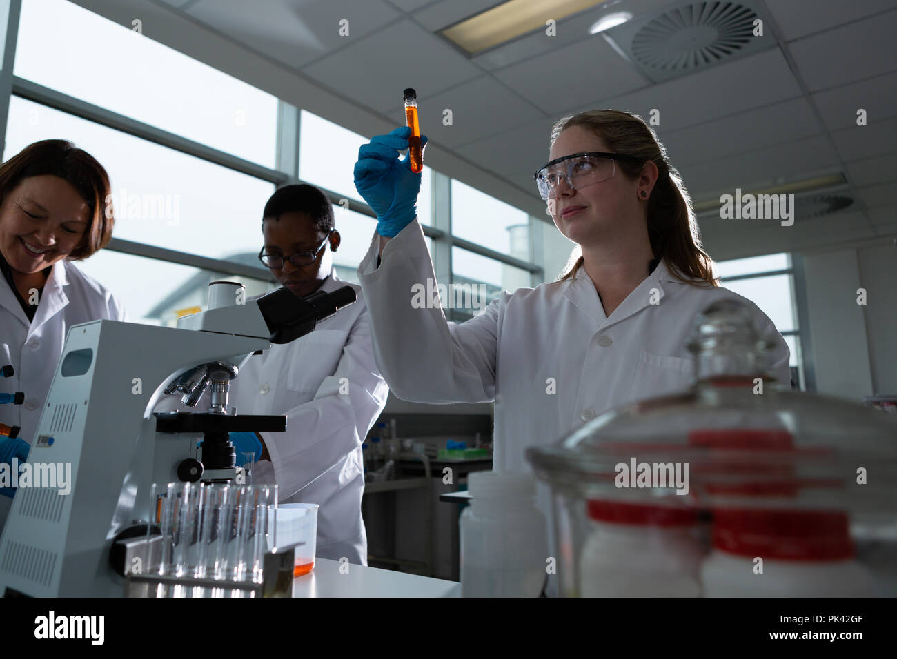 Team of scientists experimenting together Stock Photo - Alamy
