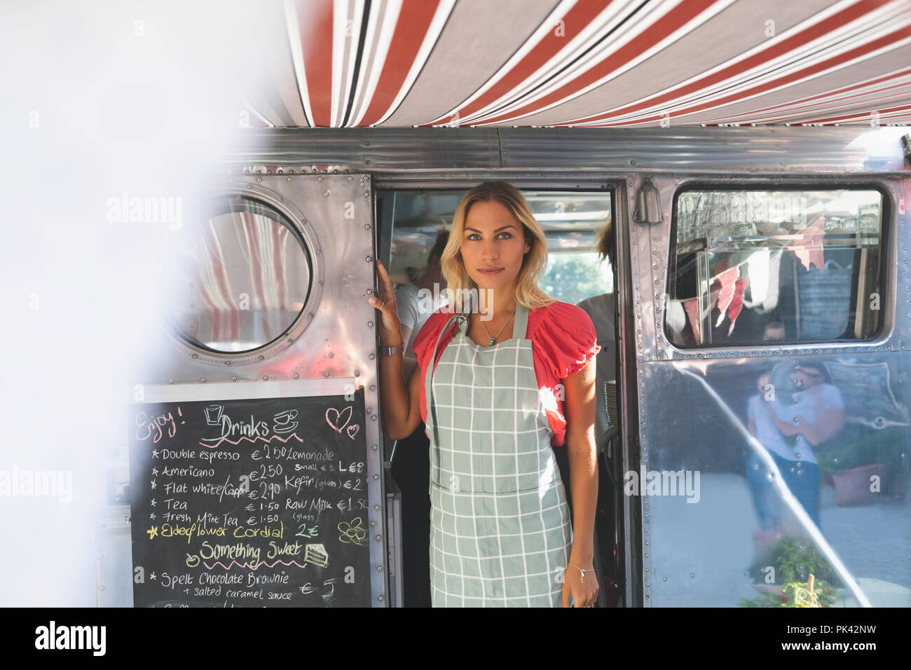 Female waitress standing in food truck Stock Photo - Alamy