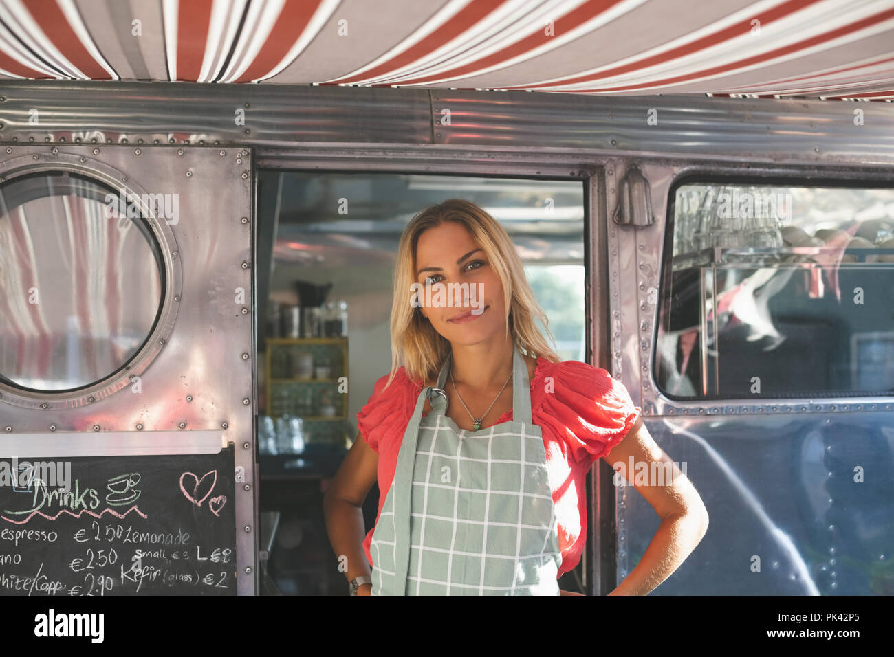 Female waitress standing in food truck Stock Photo - Alamy
