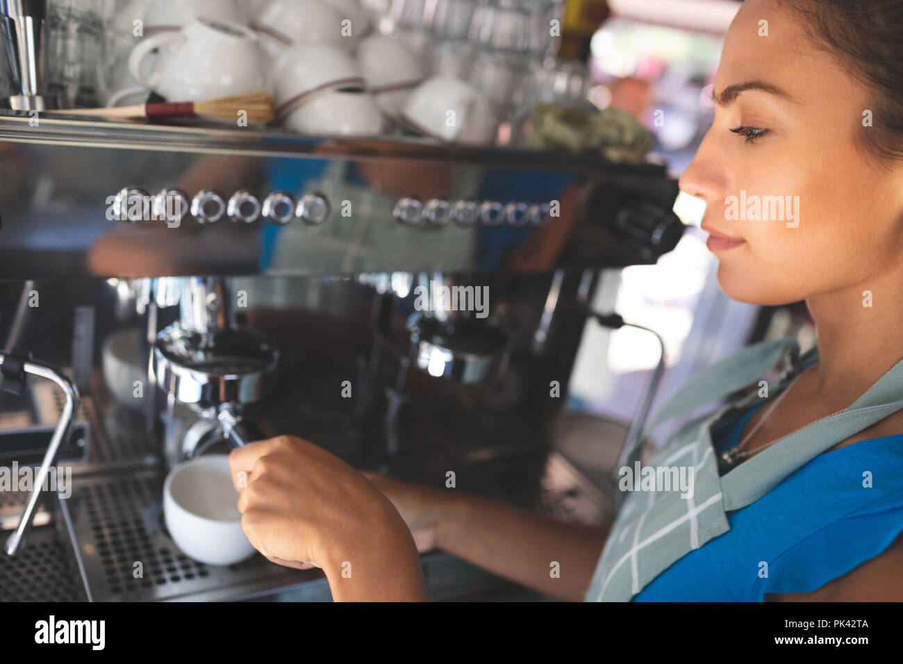 Woman waitress preparing coffee Stock Photo - Alamy