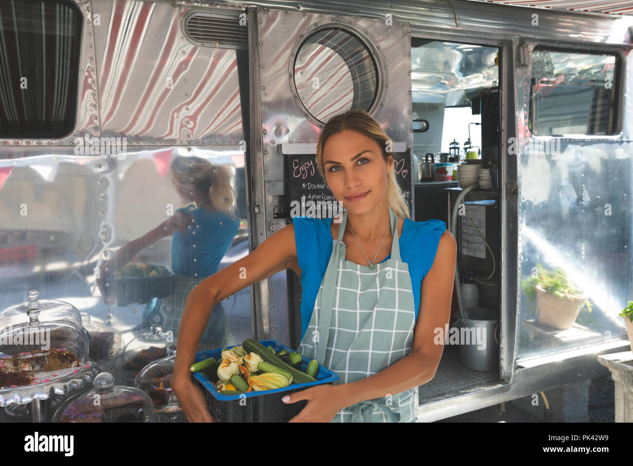 Female waitress holding vegetables in basket Stock Photo - Alamy