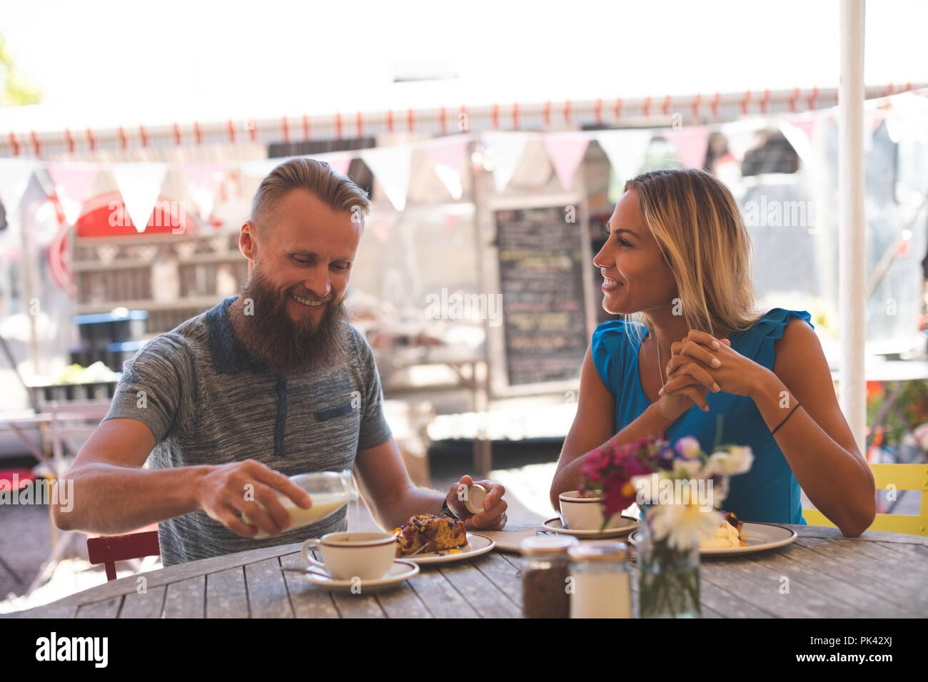 Couple having breakfast in outdoor cafe Stock Photo - Alamy