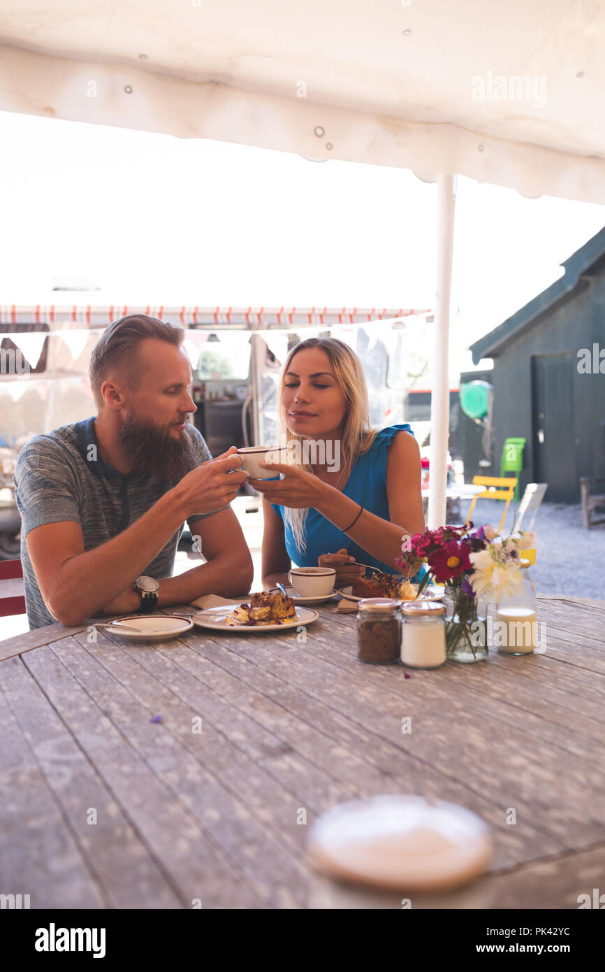Couple having coffee in outdoor cafe Stock Photo - Alamy