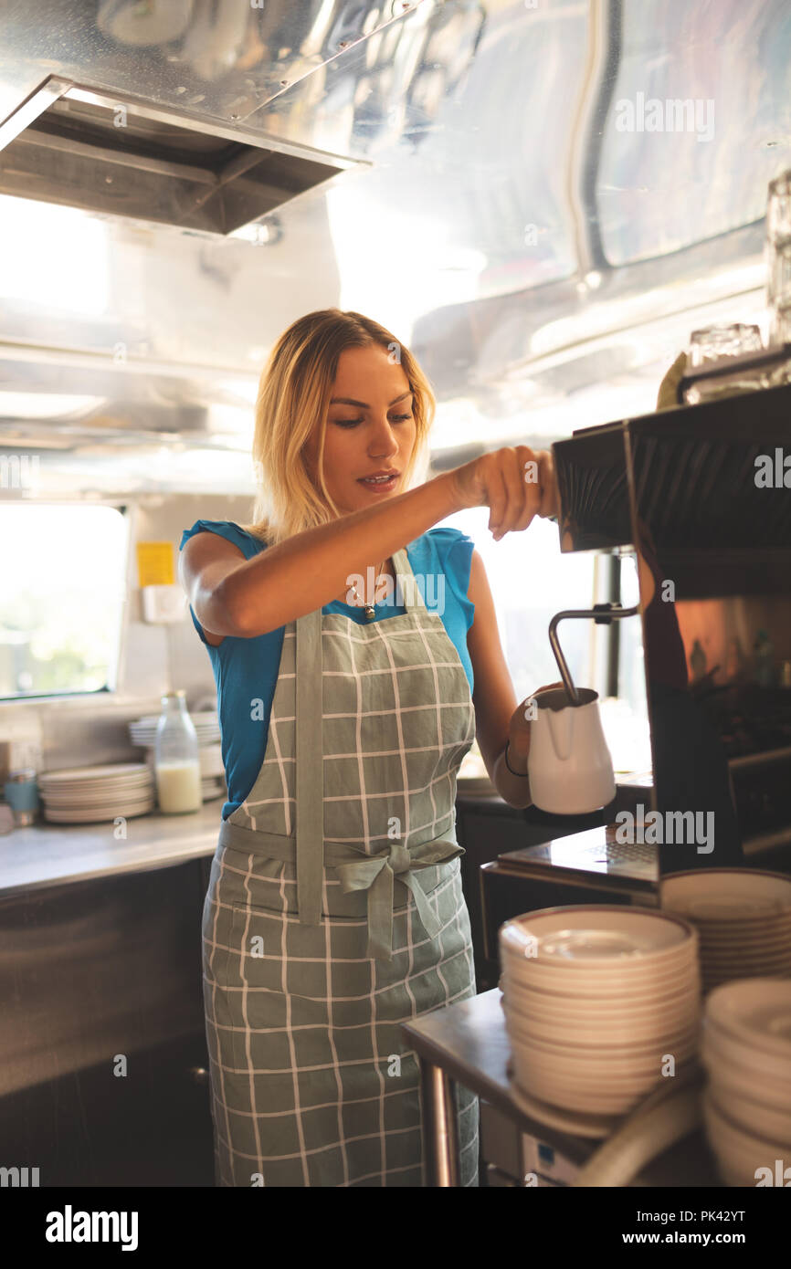 Female waiter preparing coffee in food truck Stock Photo - Alamy