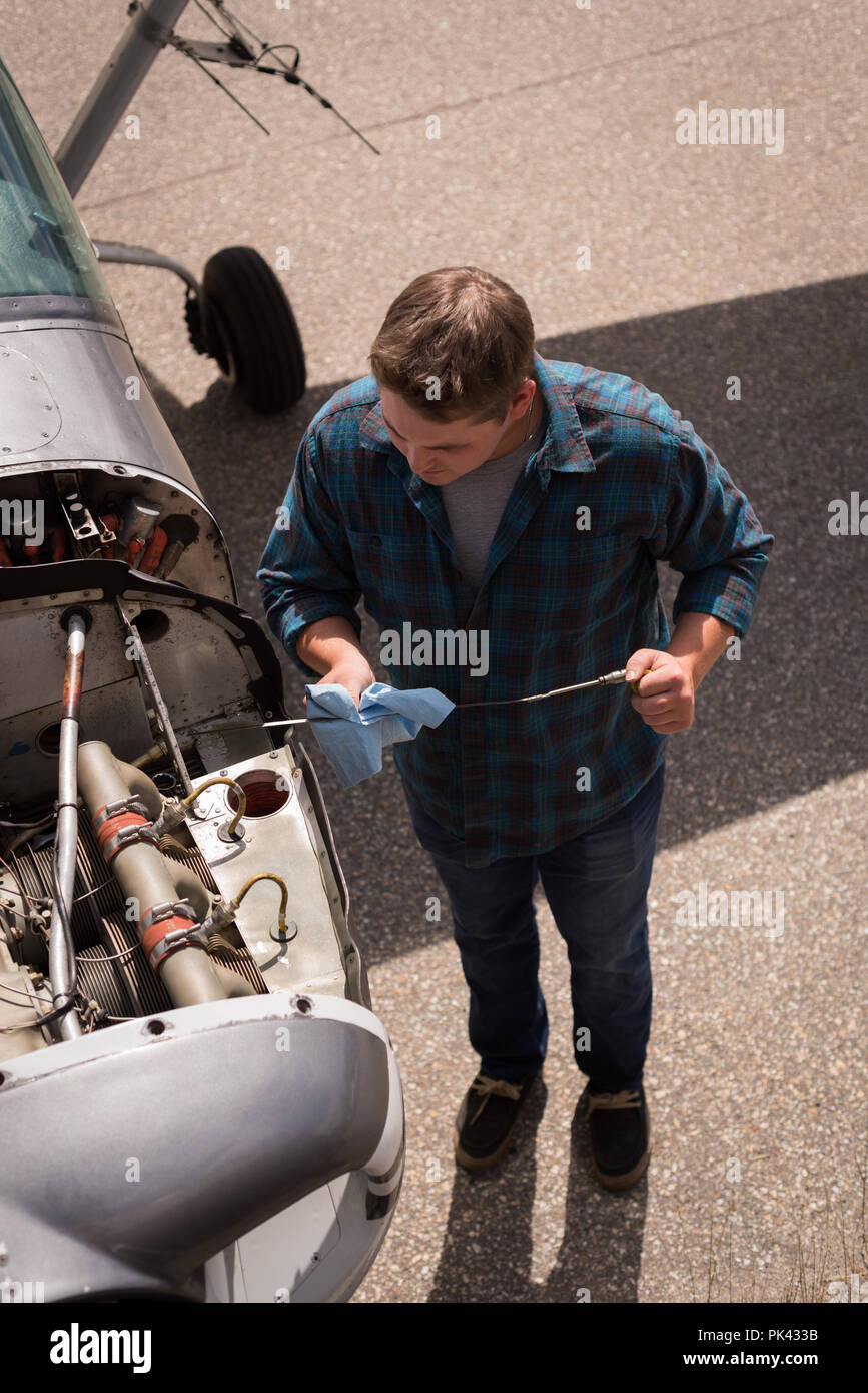 Engineer servicing aircraft engine near hangar Stock Photo - Alamy