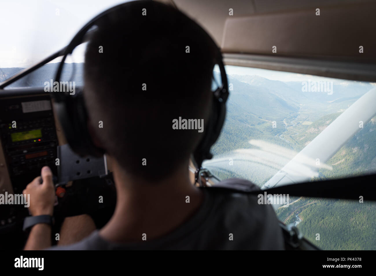 Pilot flying aircraft over mountains and landscape Stock Photo - Alamy