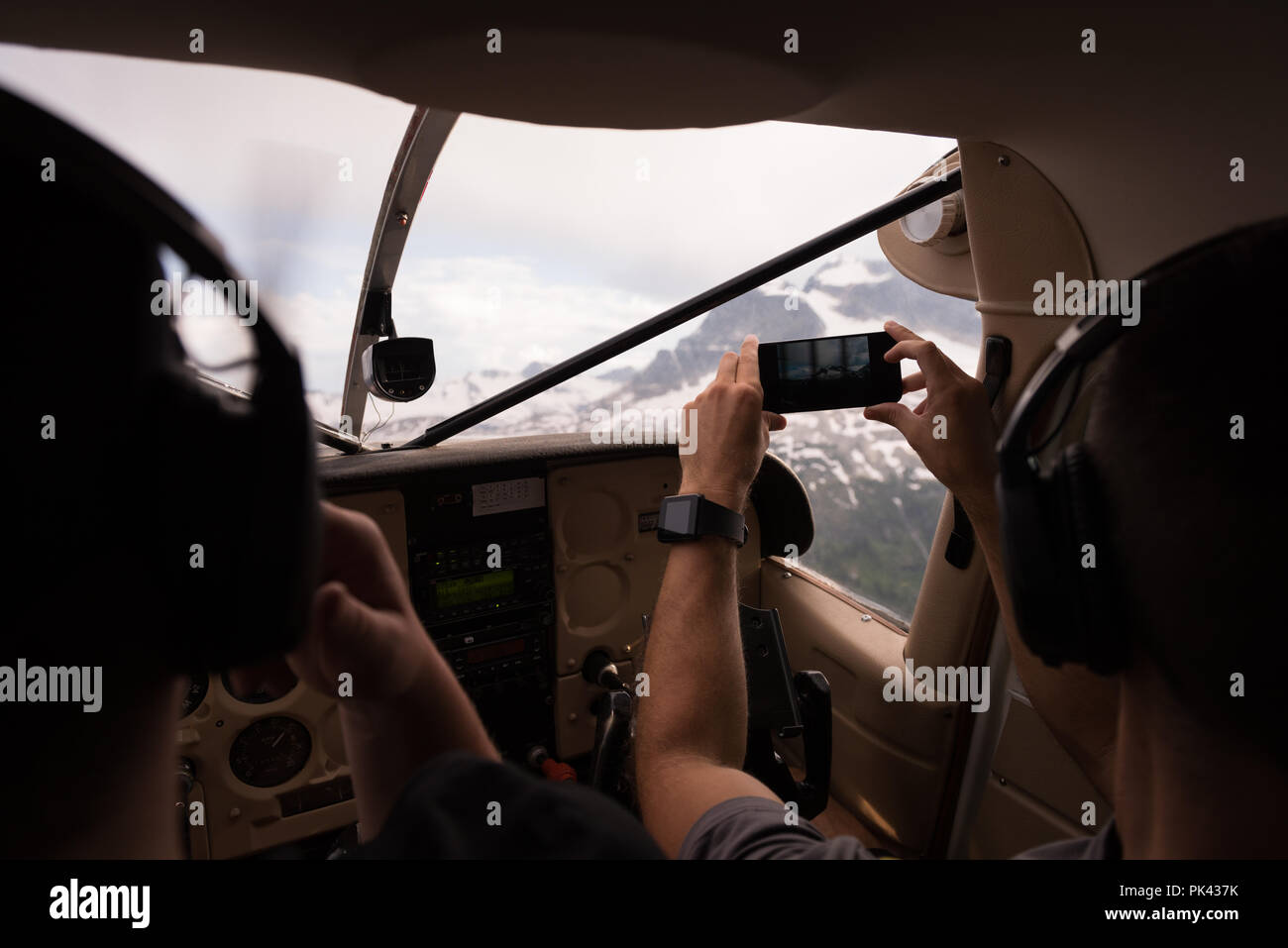 Pilot taking photos with mobile phone while flying Stock Photo - Alamy