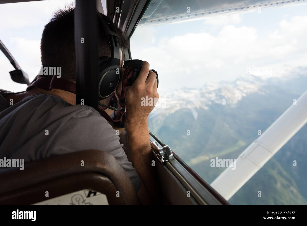 Pilot taking photos with camera while flying Stock Photo - Alamy
