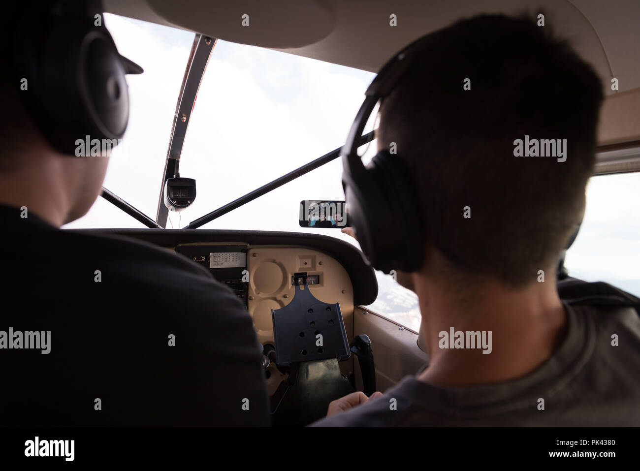 Pilots taking selfie with mobile phone while flying Stock Photo - Alamy