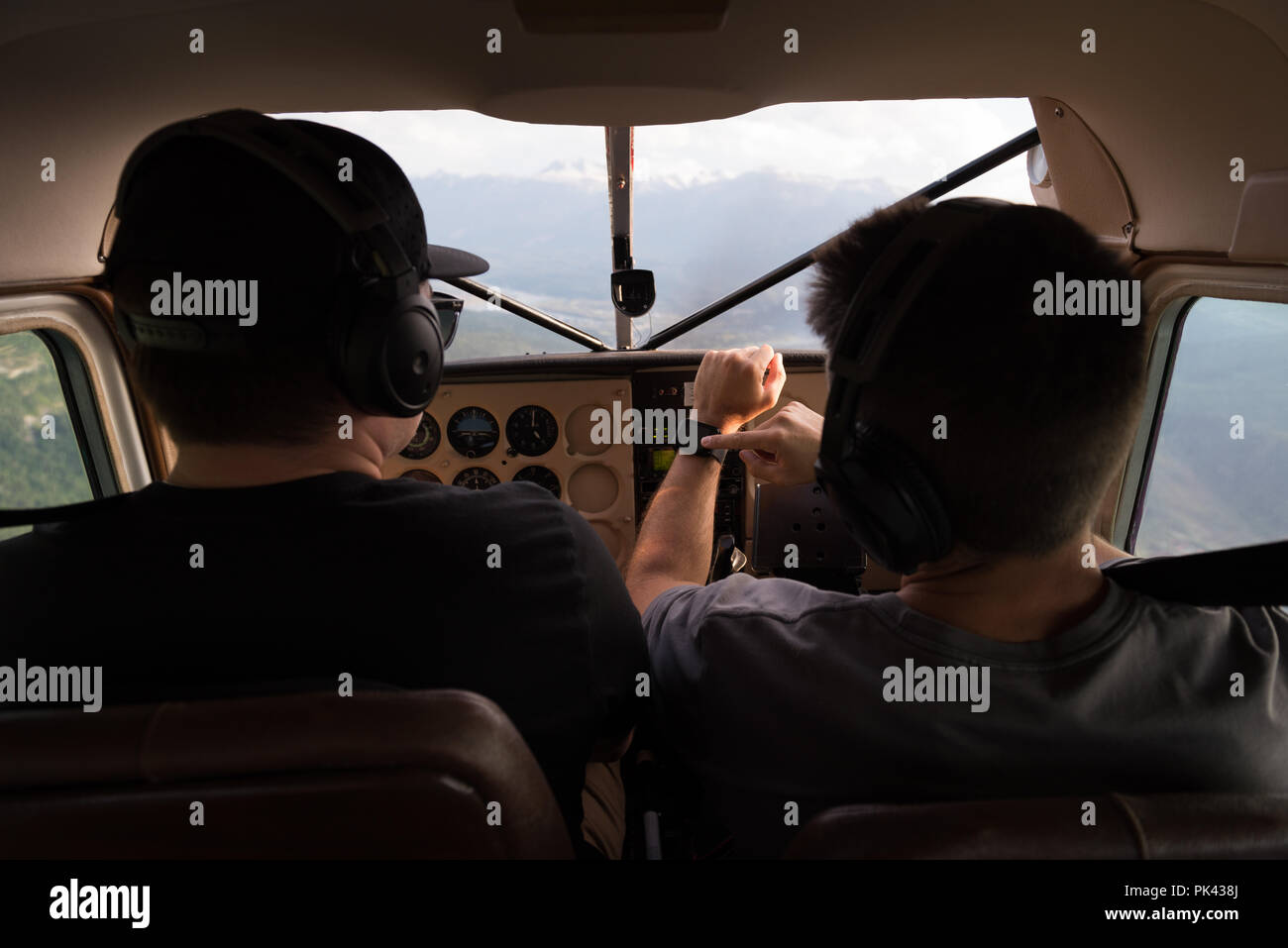 Pilot using smartwatch while flying Stock Photo - Alamy