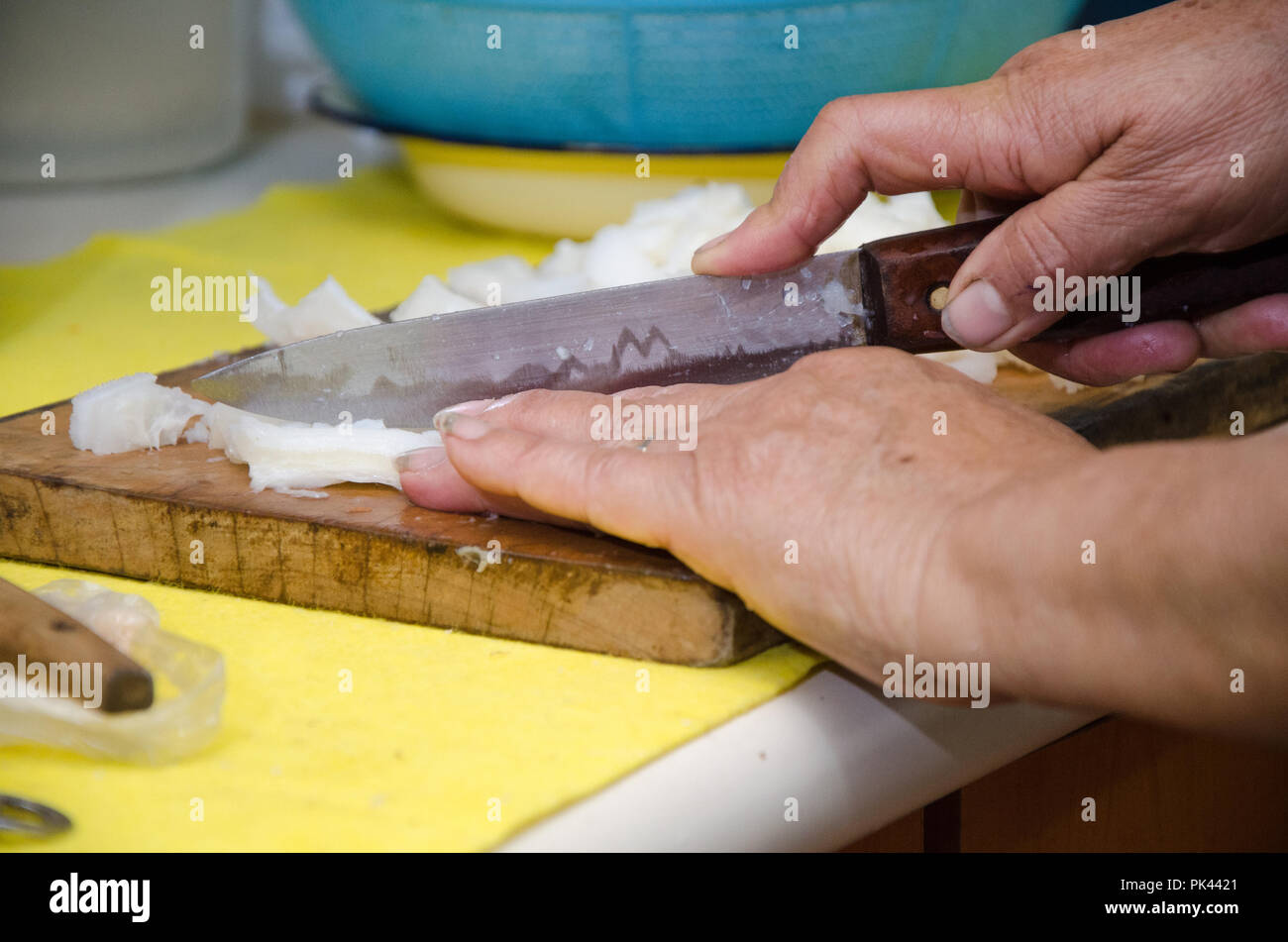 Woman's hands in the kitchen cutting a piece of meat into pieces Stock ...