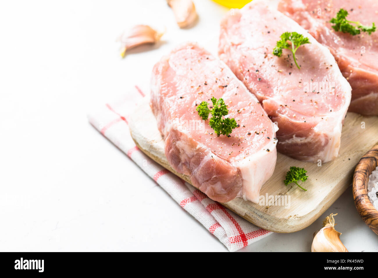 Pork meat steak, slices pork loin on white with herbs and spices Stock ...