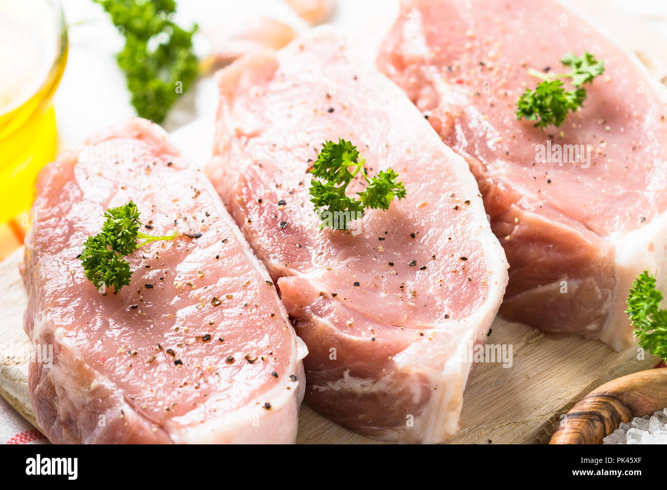 Pork meat steak, slices pork loin on white with herbs and spices Stock ...