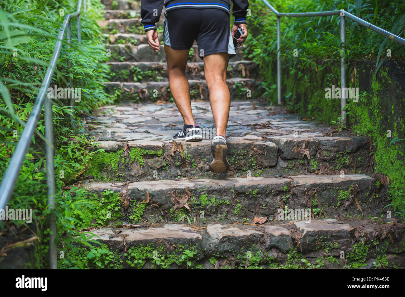 Athlete man with strong muscles running on the staircase for fitness ...