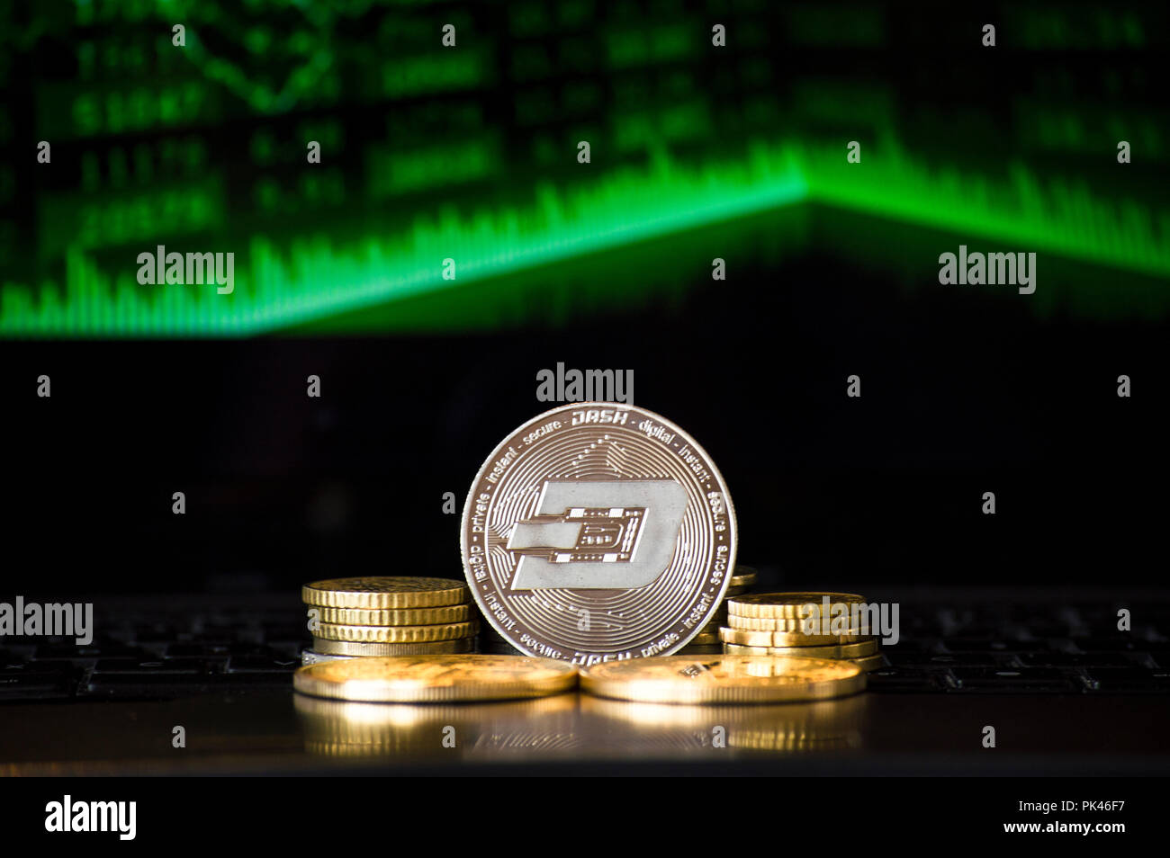 Silver Dash and coins on laptop keyboard Stock Photo - Alamy